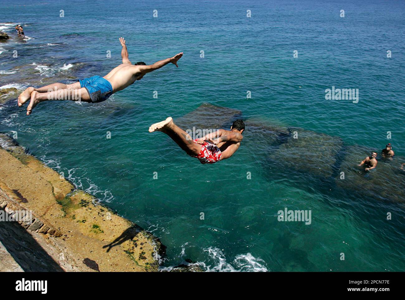 Two Lebanese man dive into the Mediterranean Sea off the Corniche in ...