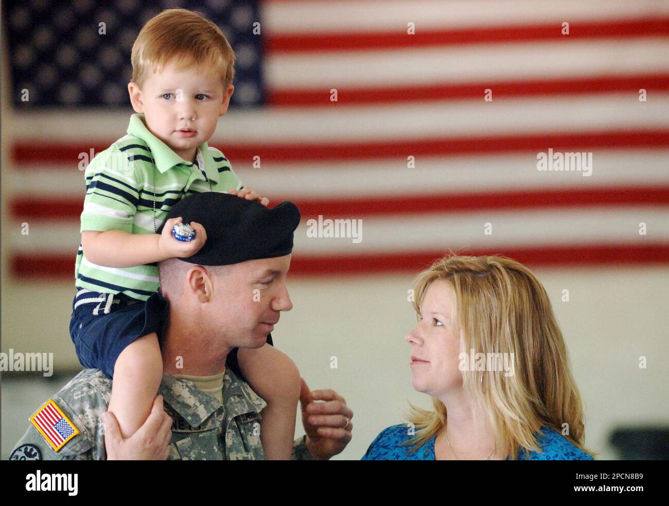 Capt. Steve Arnett of Emmett holds his son Camden, 3, as he speaks with ...