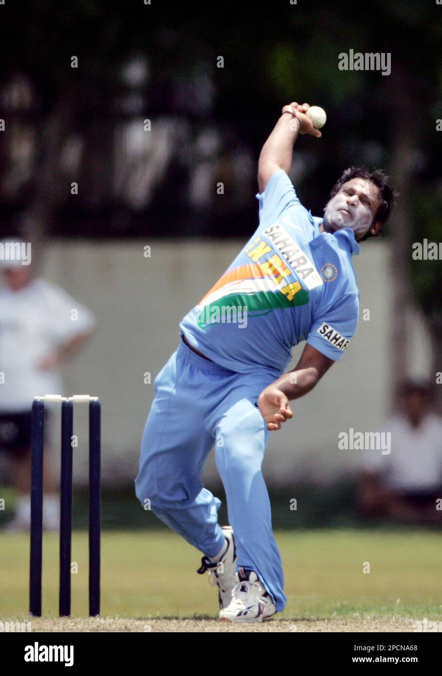 Indian cricketer Ramesh Powar bowls during a practice match against Sri ...
