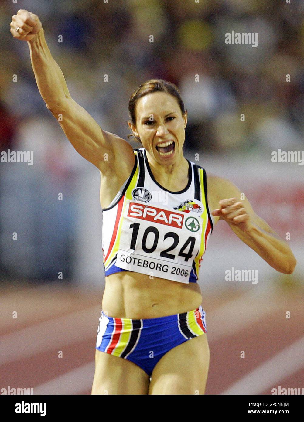 Belgium's Kim Gevaert celebrates as she crosses the finish line to win ...