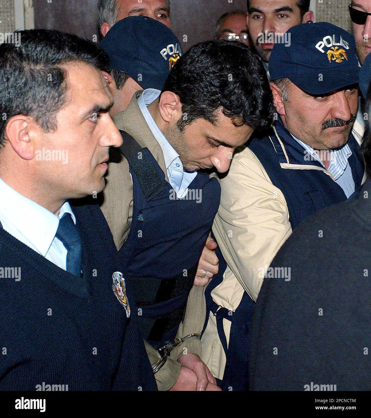 ** FILE ** Police escort Alparslan Arslan, a Turkish gunman who killed ...