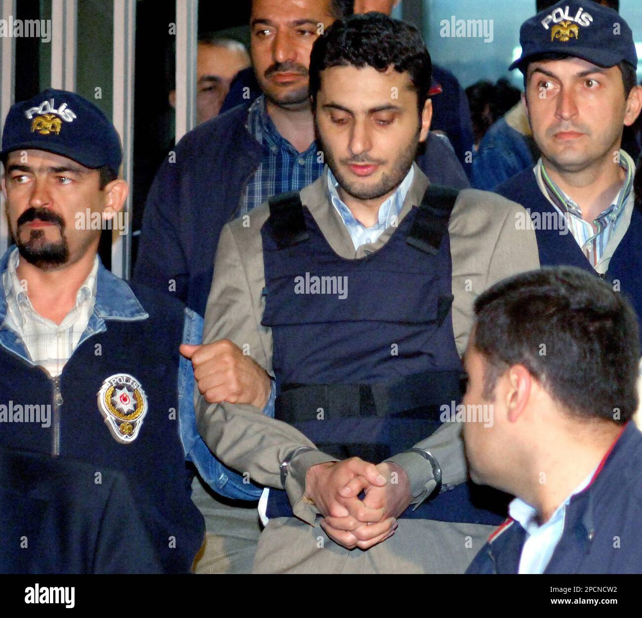 ** FILE ** Police escort Alparslan Arslan, a Turkish gunman who killed ...