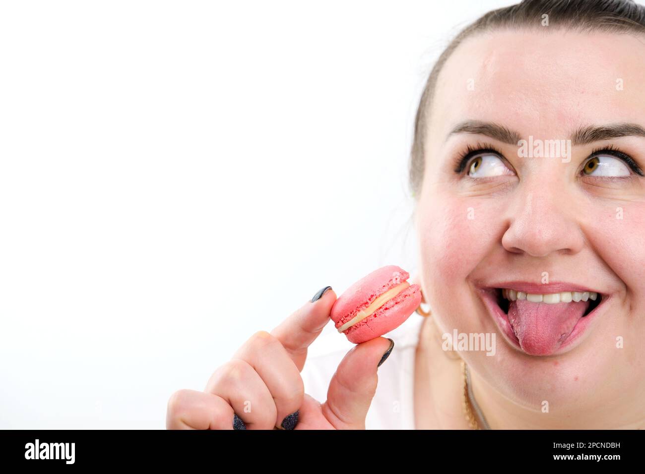 plump woman biting pink pasta laughing stuck out tongue raised her eyes ...