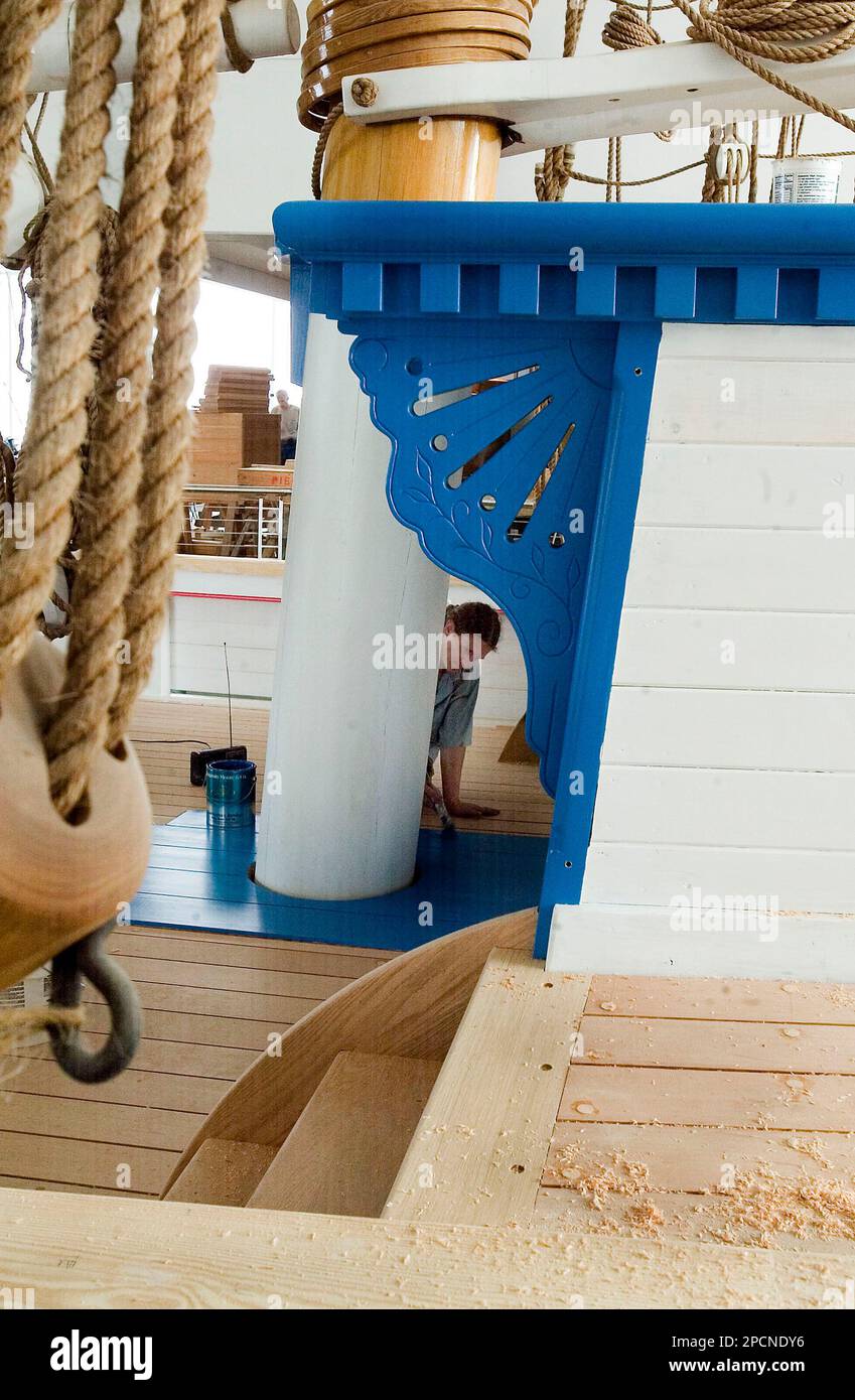Shaun Sacho paints the floor boards of a full-scale model of an 1800's ...