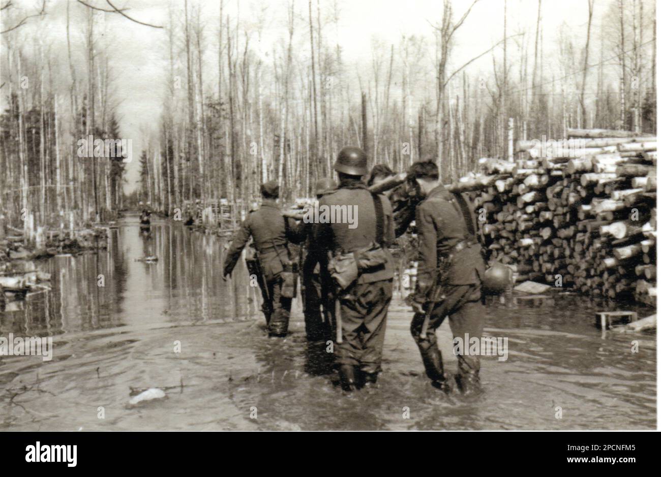 World War Two B&W photo German Soldiers carry a wounded comrade on an ...
