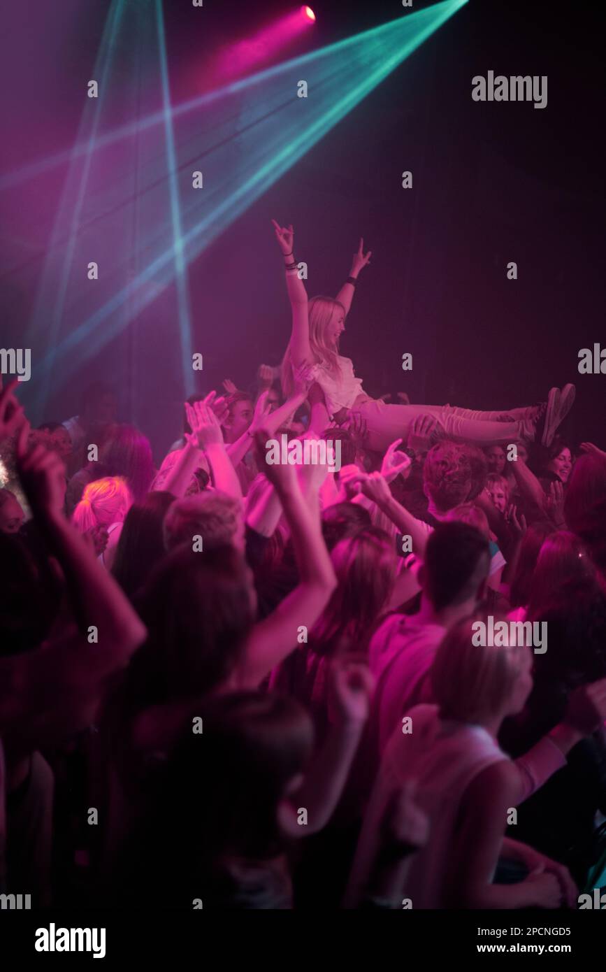 Carried by an awesome crowd. A stage diver being carried across the ...