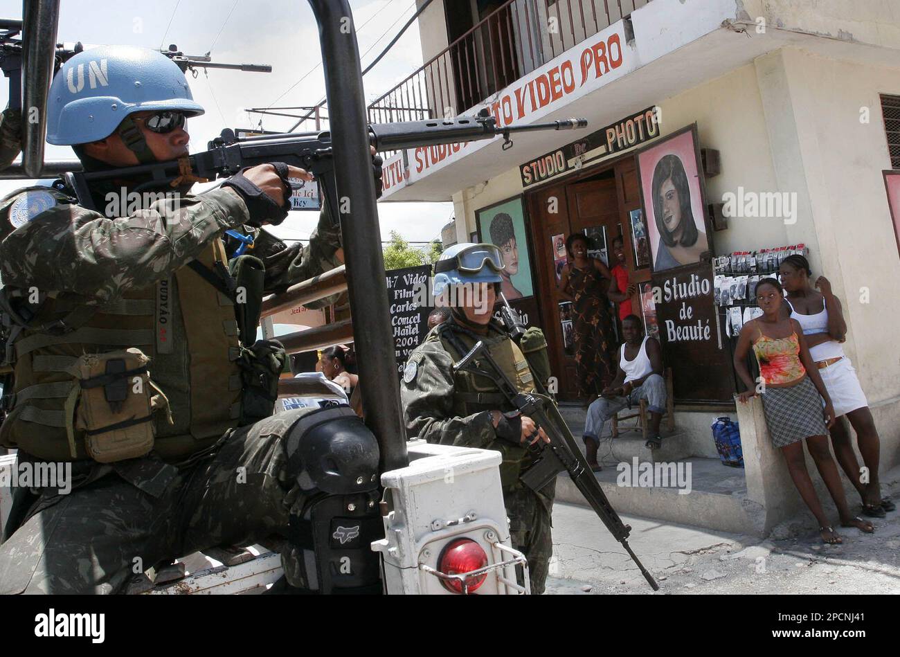 U.N. Brazilian peacekeepers patrol a street in the slum of Cite ...
