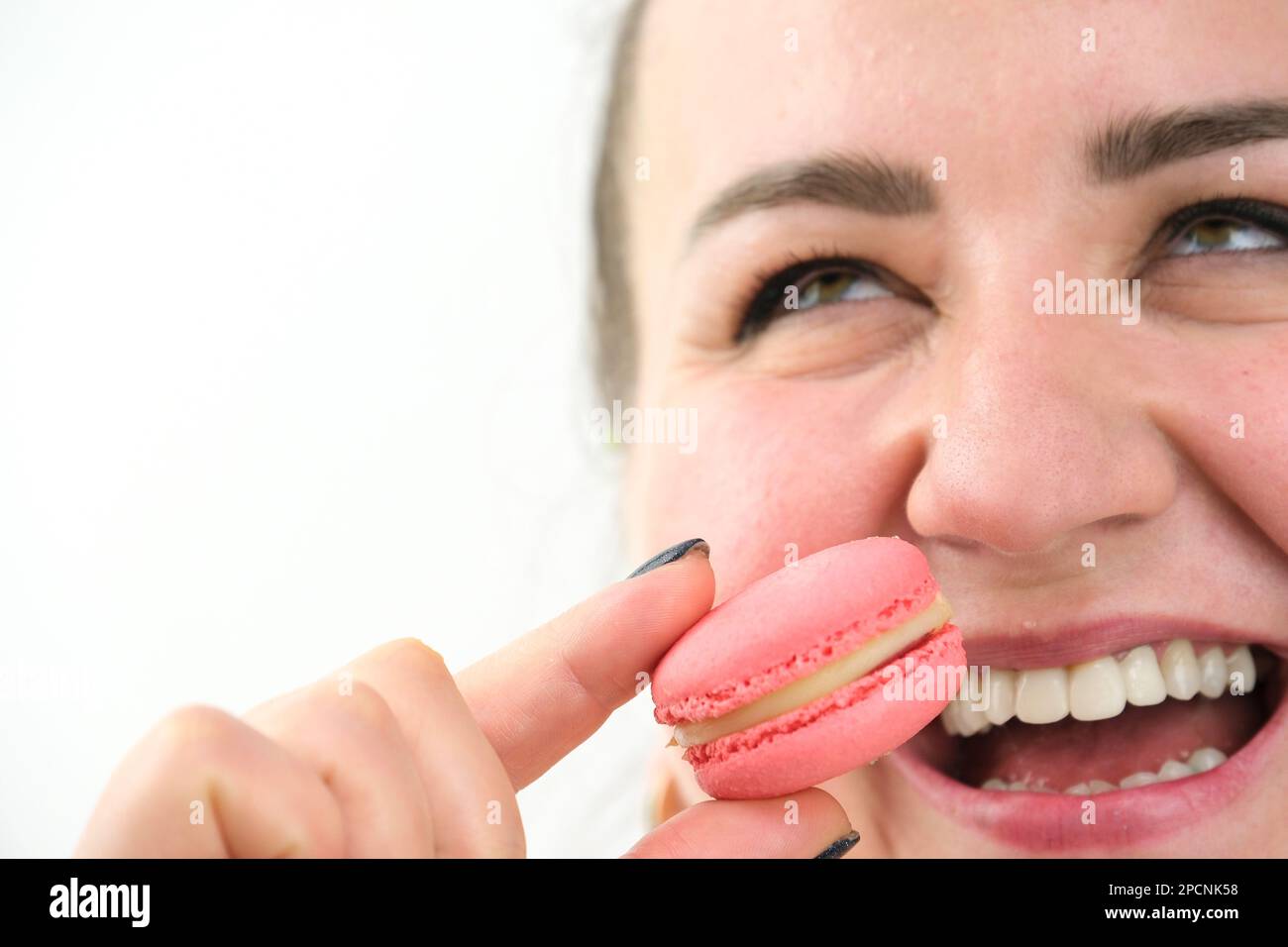 beautiful woman in hands with macarons pink color delicious food ...