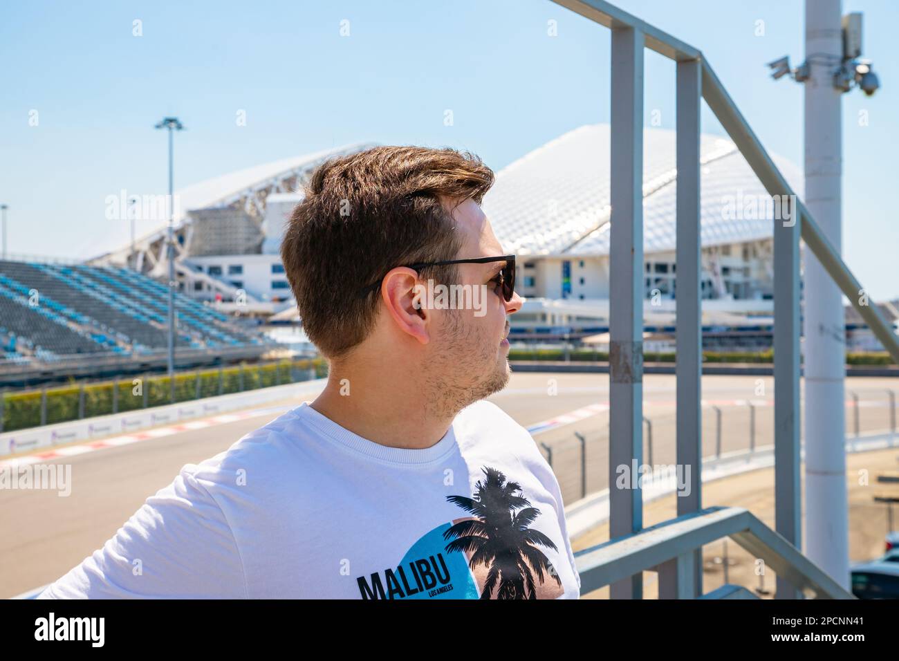 male man in black sunglasses over empty race car track, motorcycle ...