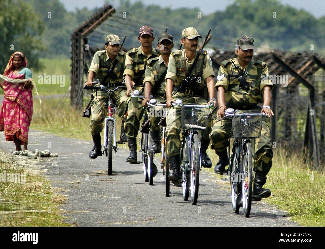 Indian border security force soldiers patrol near the India-Bangladesh ...
