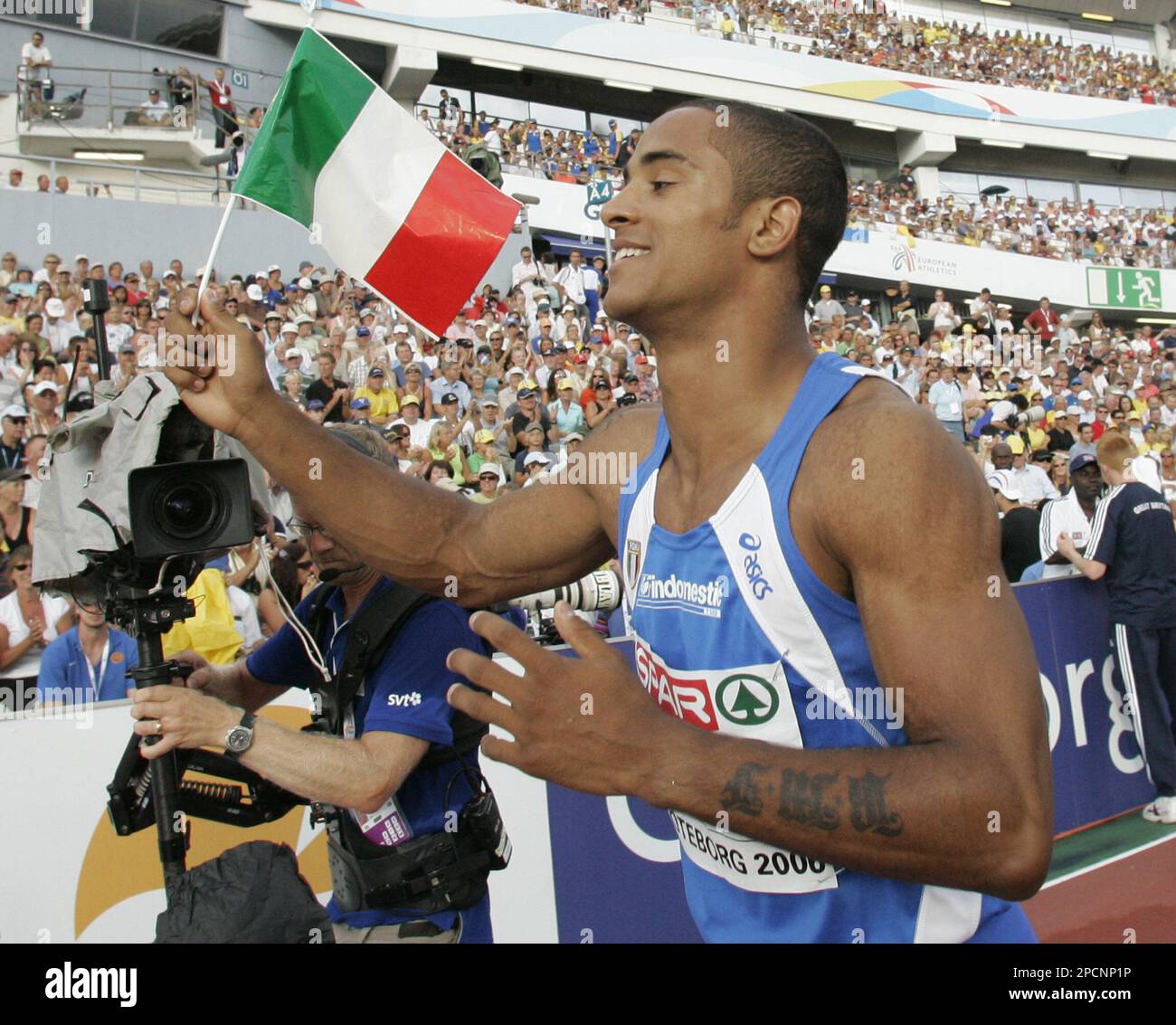 Italy's Andrew Howe carries an Italian flag, after winning the gold ...