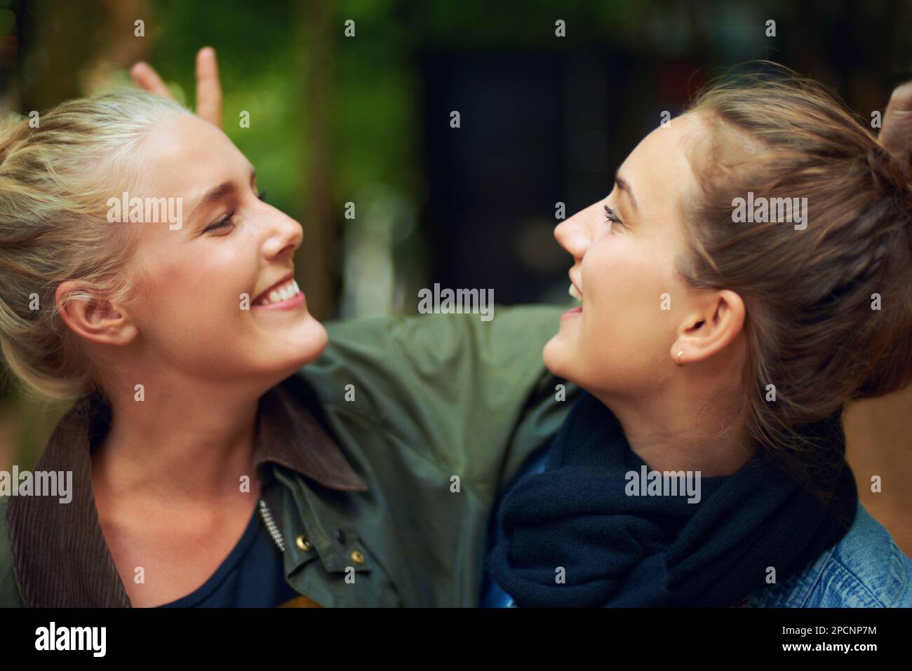 Having a fun time. two young women having a good time at an outdoor ...