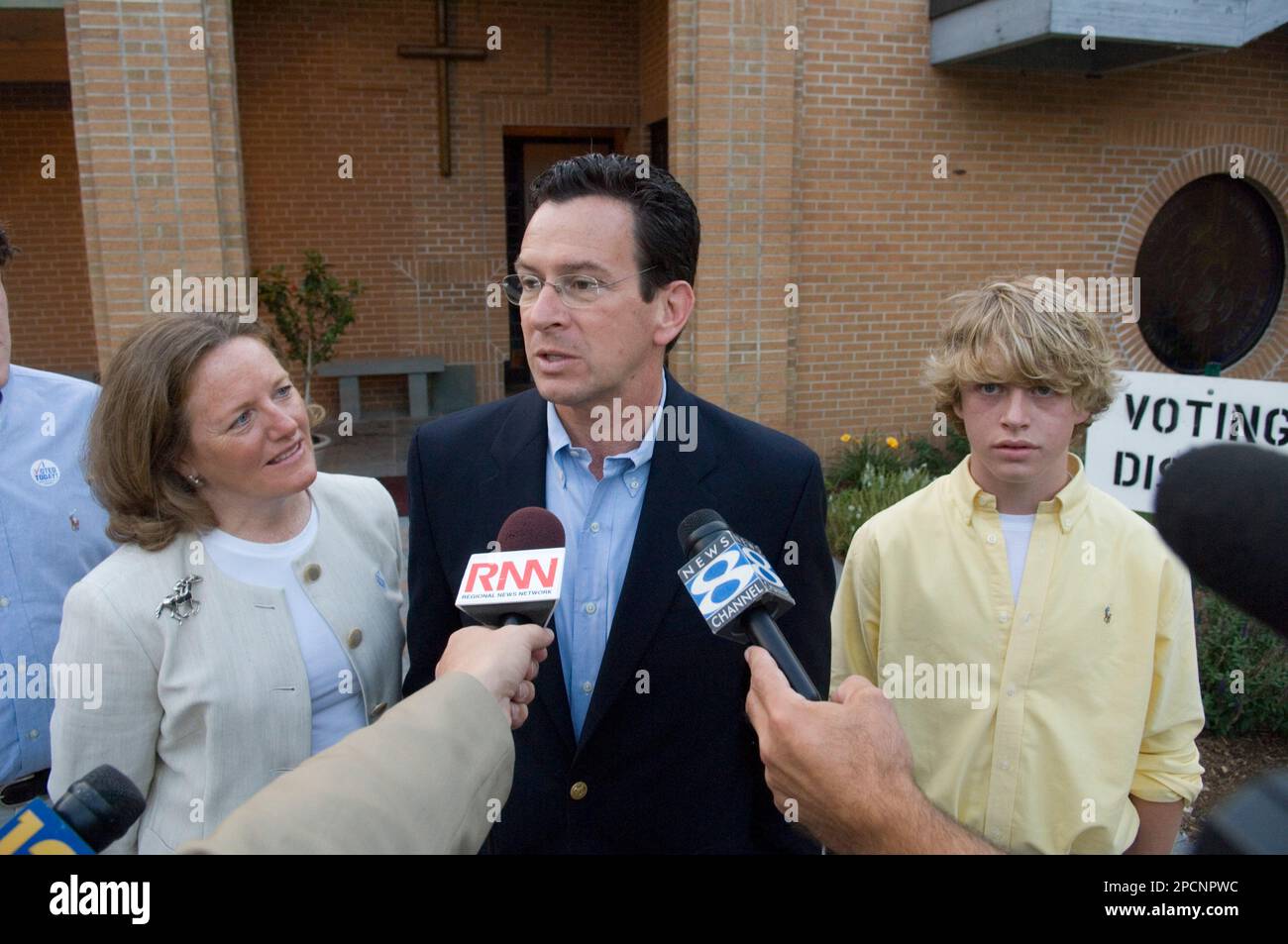 Stamford Mayor Dannel Malloy, center, talks to the media after voting ...
