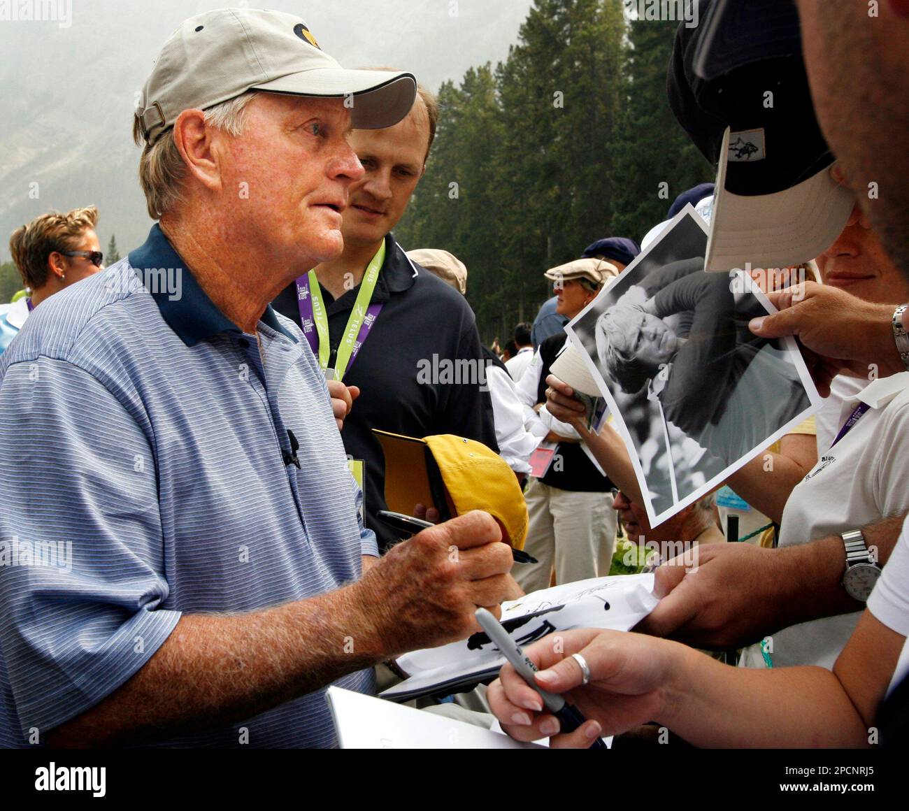 Jack Nicklaus, left, signs autographs as a fan holds a 1970's era ...