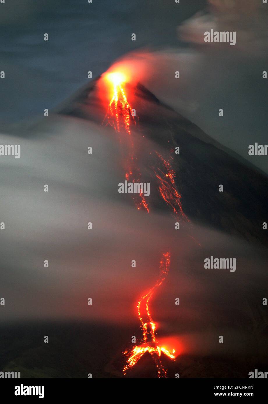Lava cascades down the slopes of Mayon volcano in its continuing "mild ...