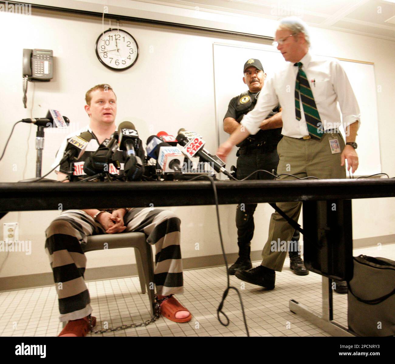 Public defender Garrett Simpson, right, steps in to end a press ...