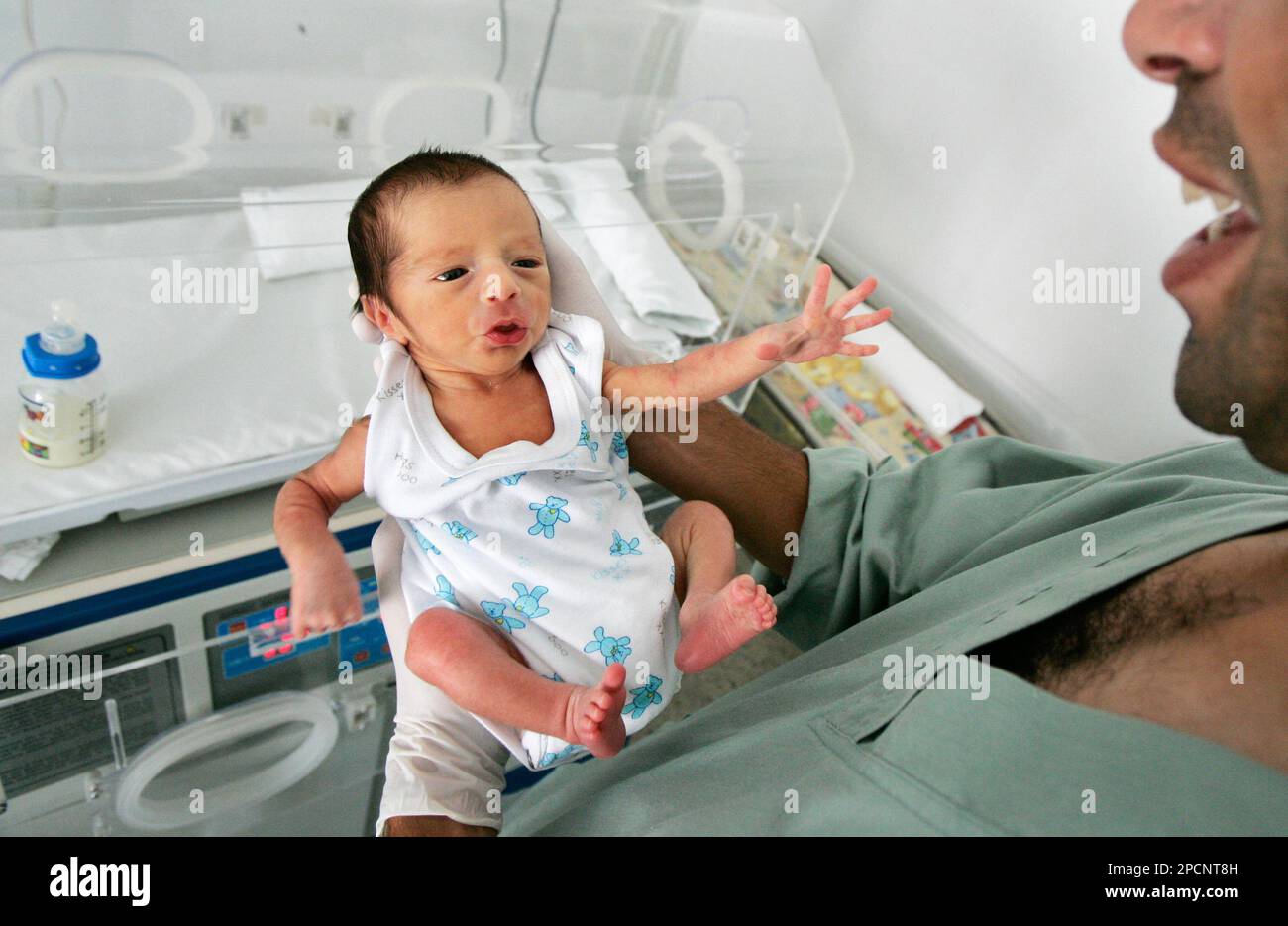 Two-week old baby "Raad" is removed from his incubator in order to feed ...