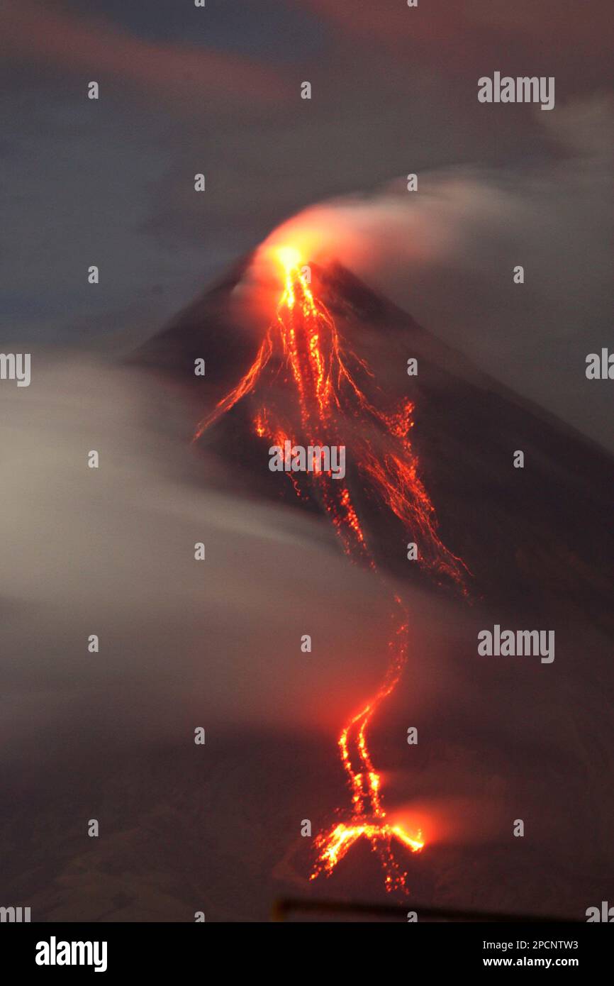Lava cascades down the slopes of Mayon volcano in its continuing "mild ...