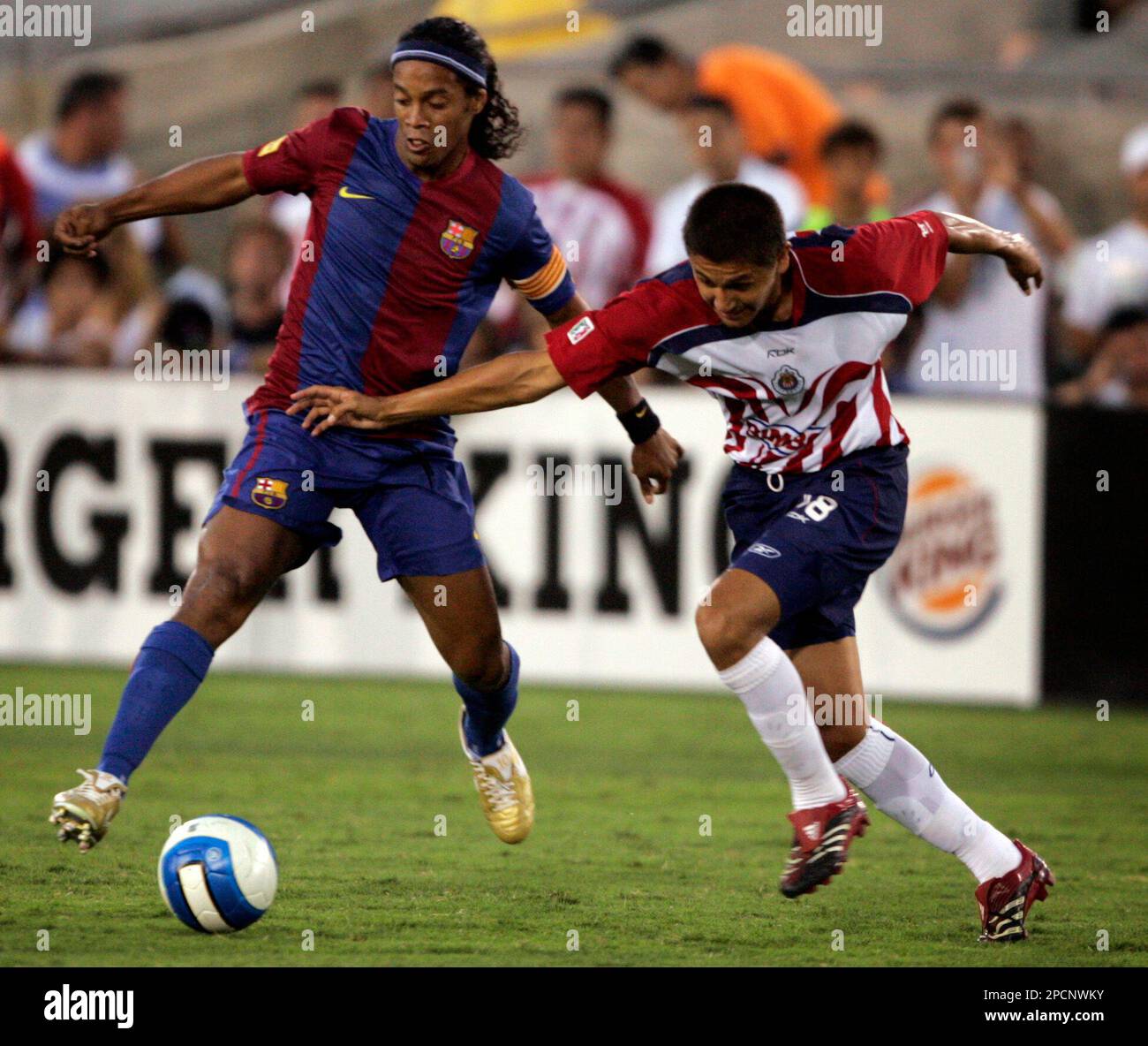 Ronaldinho of FC Barcelona ,left , dribbles past Javier Ledesma of CD ...