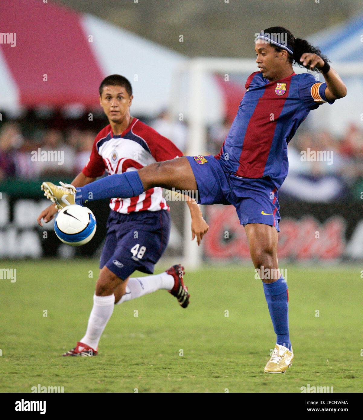 FC Barcelona's Ronaldinho kicks the ball as CD Guadalajara's Javier ...