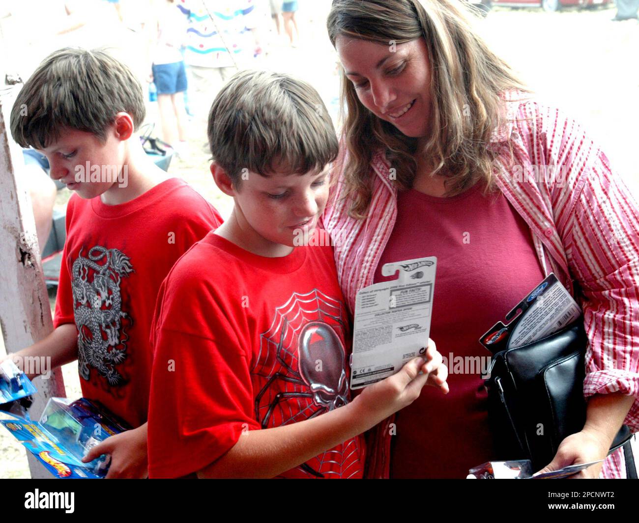 Gabriel Bird, center, shows his new Hot Wheels to his mother Angela ...