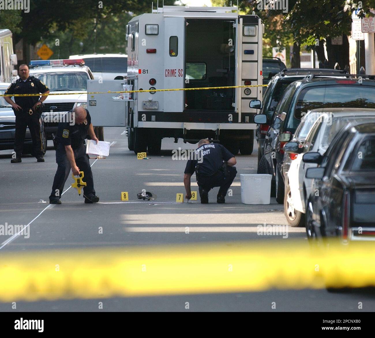 Members of the Reading Police Crime Scene Unit collect evidence in ...