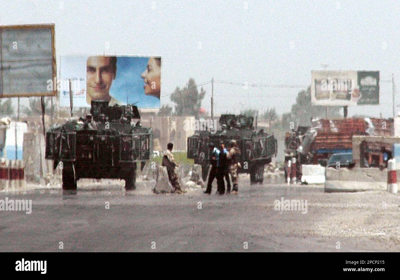 U.S. military Stryker vehicles convoy down a main highway in a Sunni ...