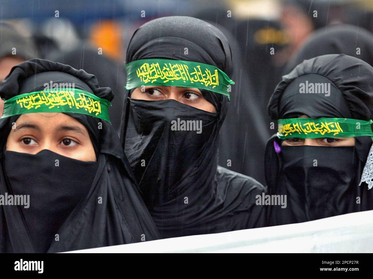 Pakistani Shiite Muslim girls wear headbands with quote from holy book ...