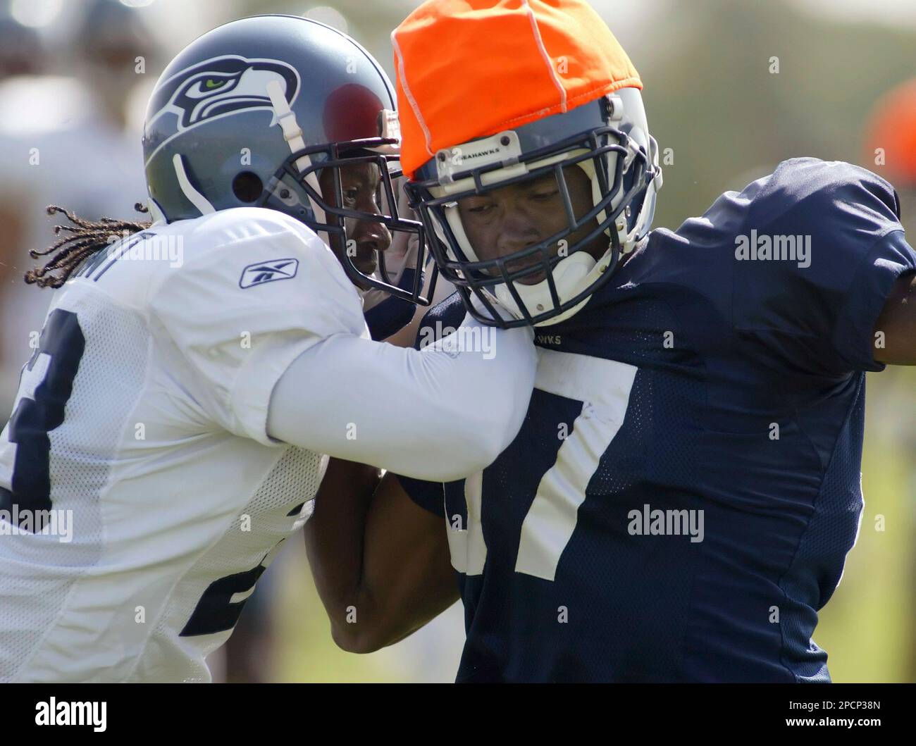 Seattle Seahawks' Marcus Trufant, left, keeps Ben Obomanu from getting ...