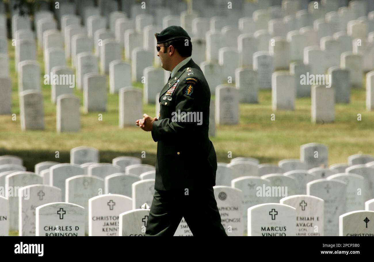 An Army special forces soldier clasp his hands as he walks among the ...