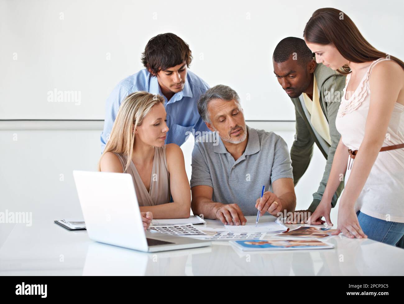 Giving input into an important project. Five colleagues working on an ...