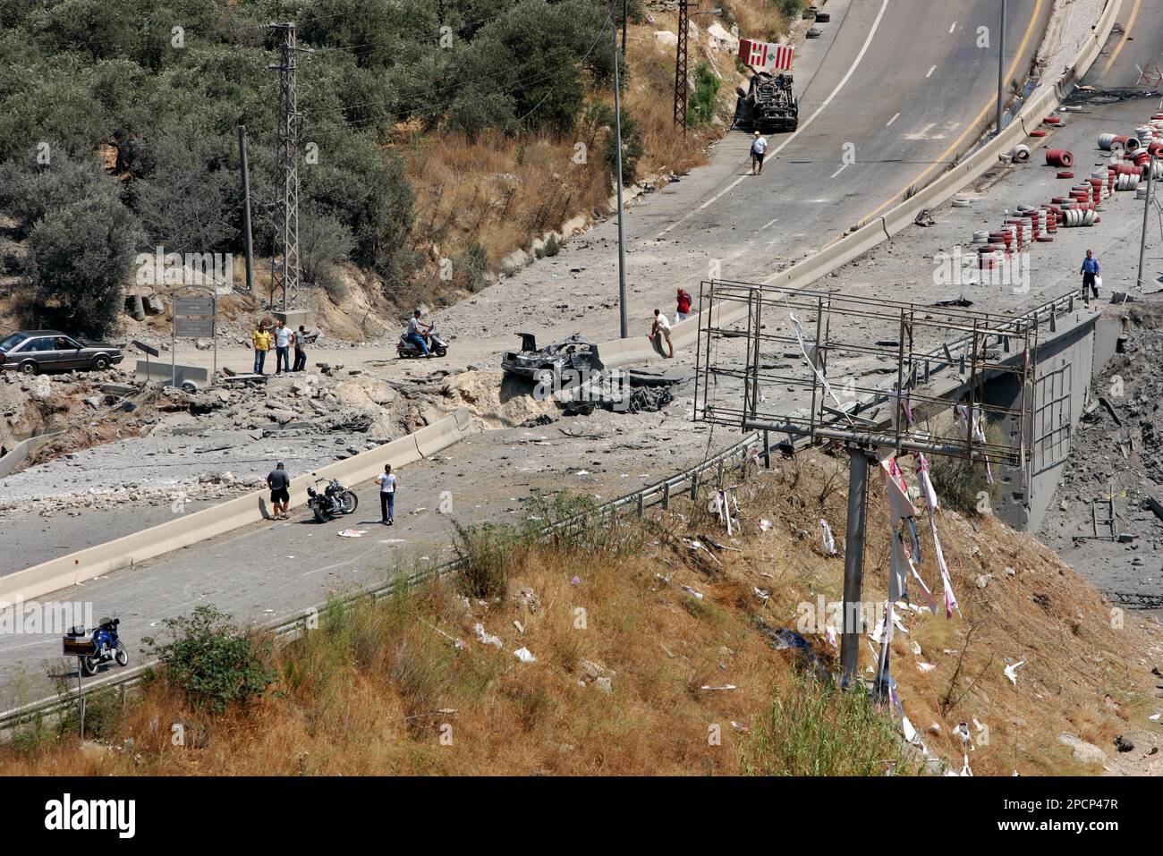 A large bomb crater is seen on the main highway linking Beirut with ...
