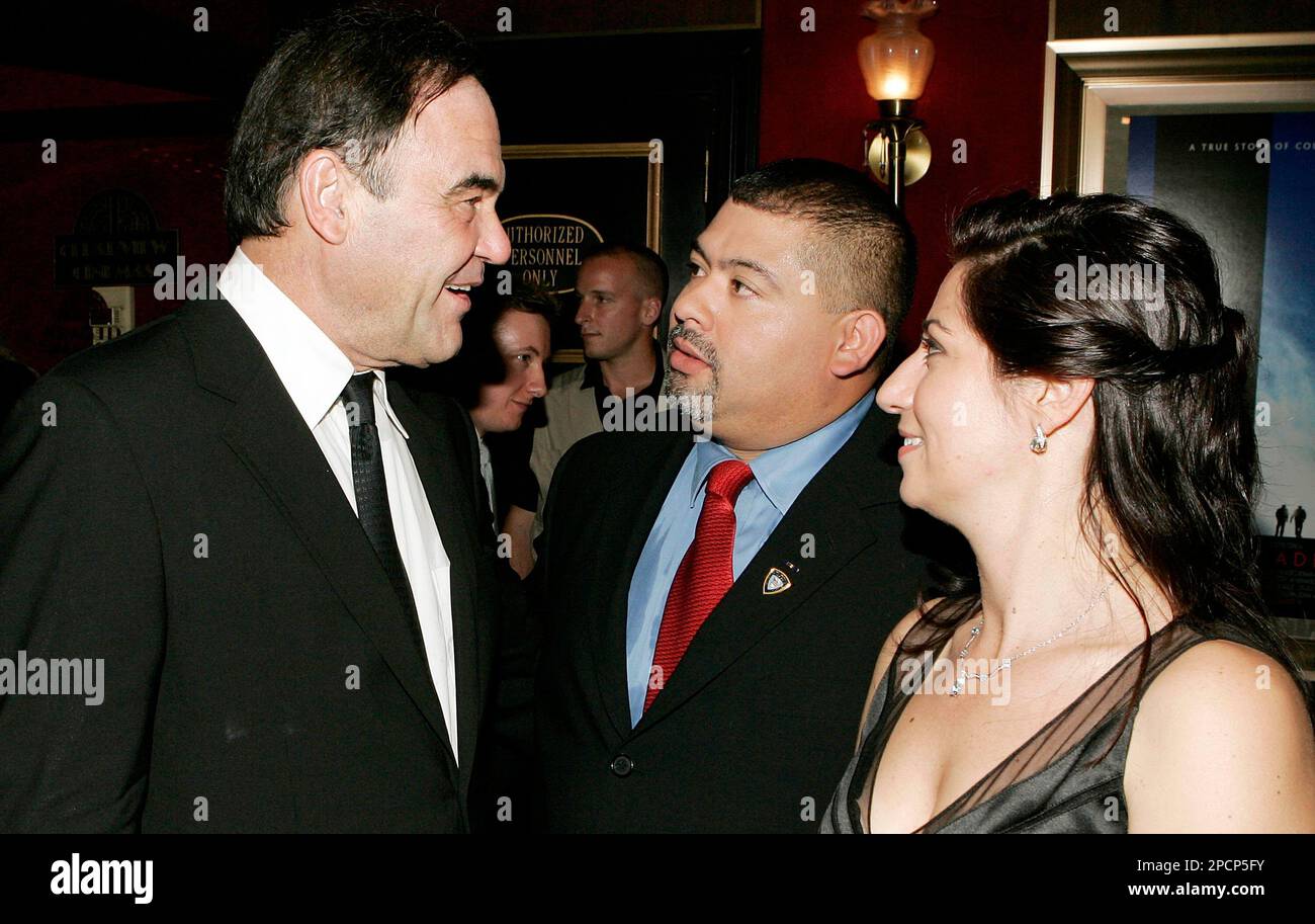 Director Oliver Stone, left speaks with Port Authority Police officer ...