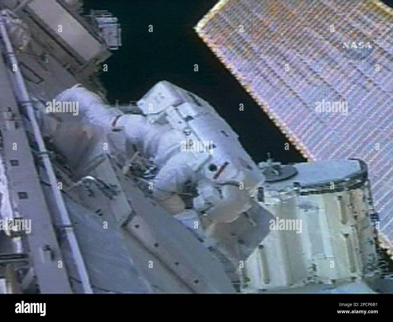 In this image made from NASA TV, astronaut Jeff Williams works on the ...