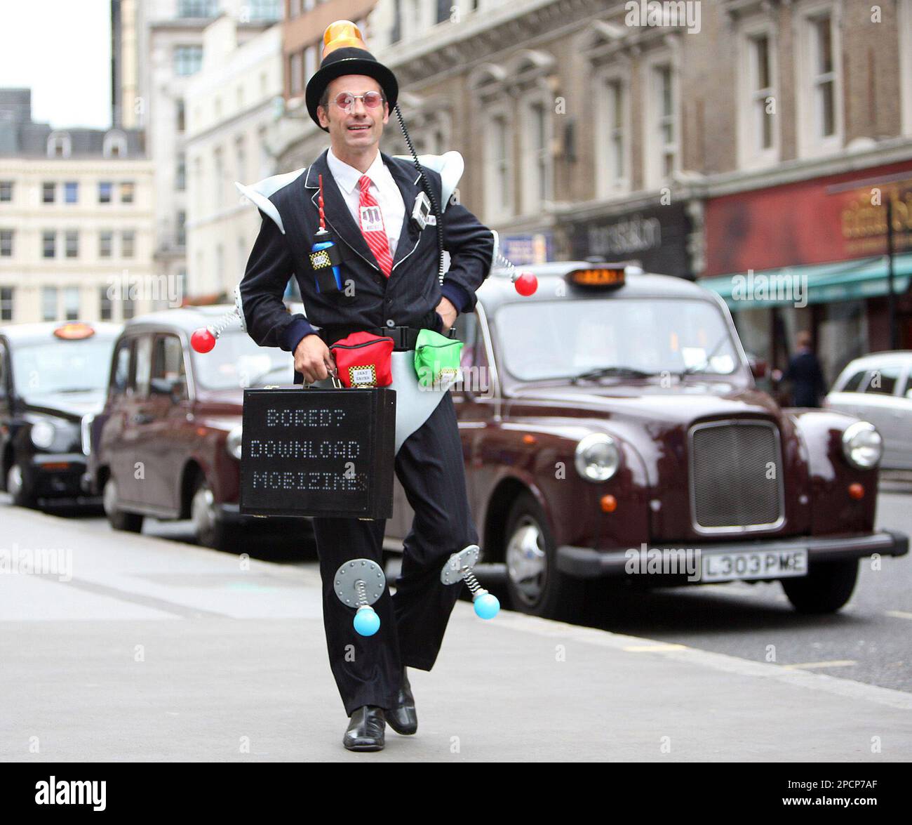 Conceptual artist Liam Yates wears his creation the 'Commute Suit' in ...