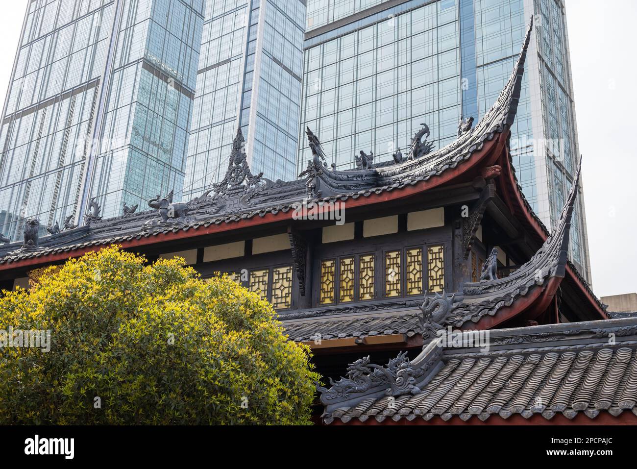 Buddhist temple buildings and modern skyscraprers against blue sky in ...