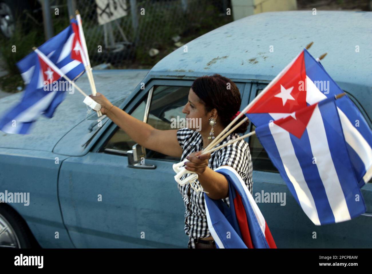 An unidentified woman sells Cuban flags on a street of Miami's Little ...