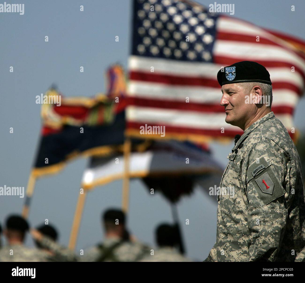Maj. Gen. Carter Ham watches soldiers march past during a change of ...