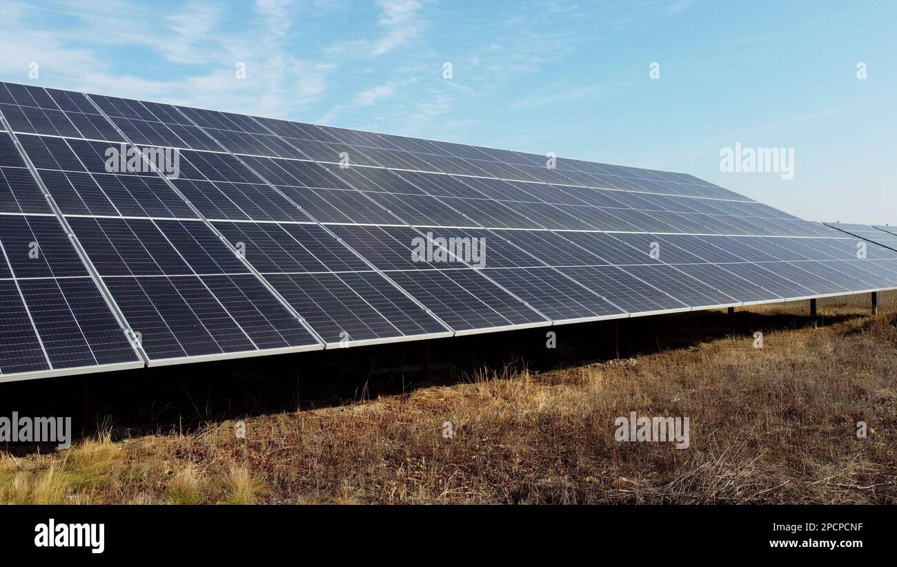Solar power plant. Flight over modules of solar power station on sunny ...
