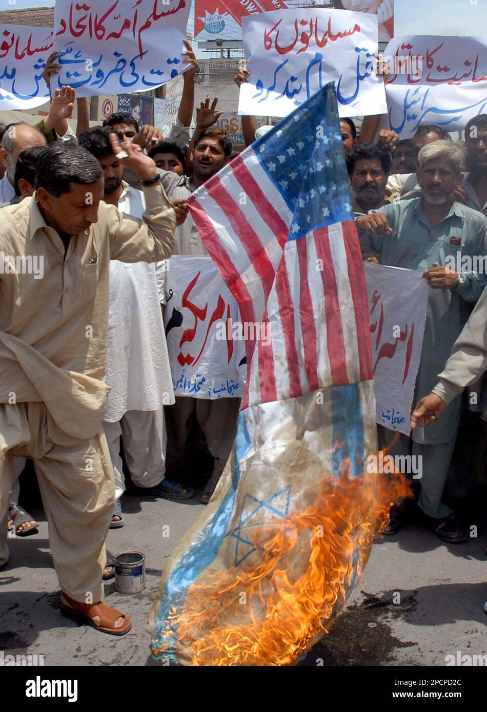 Pakistani traders burn the Israel flag during a rally, Tuesday, Aug. 1 ...