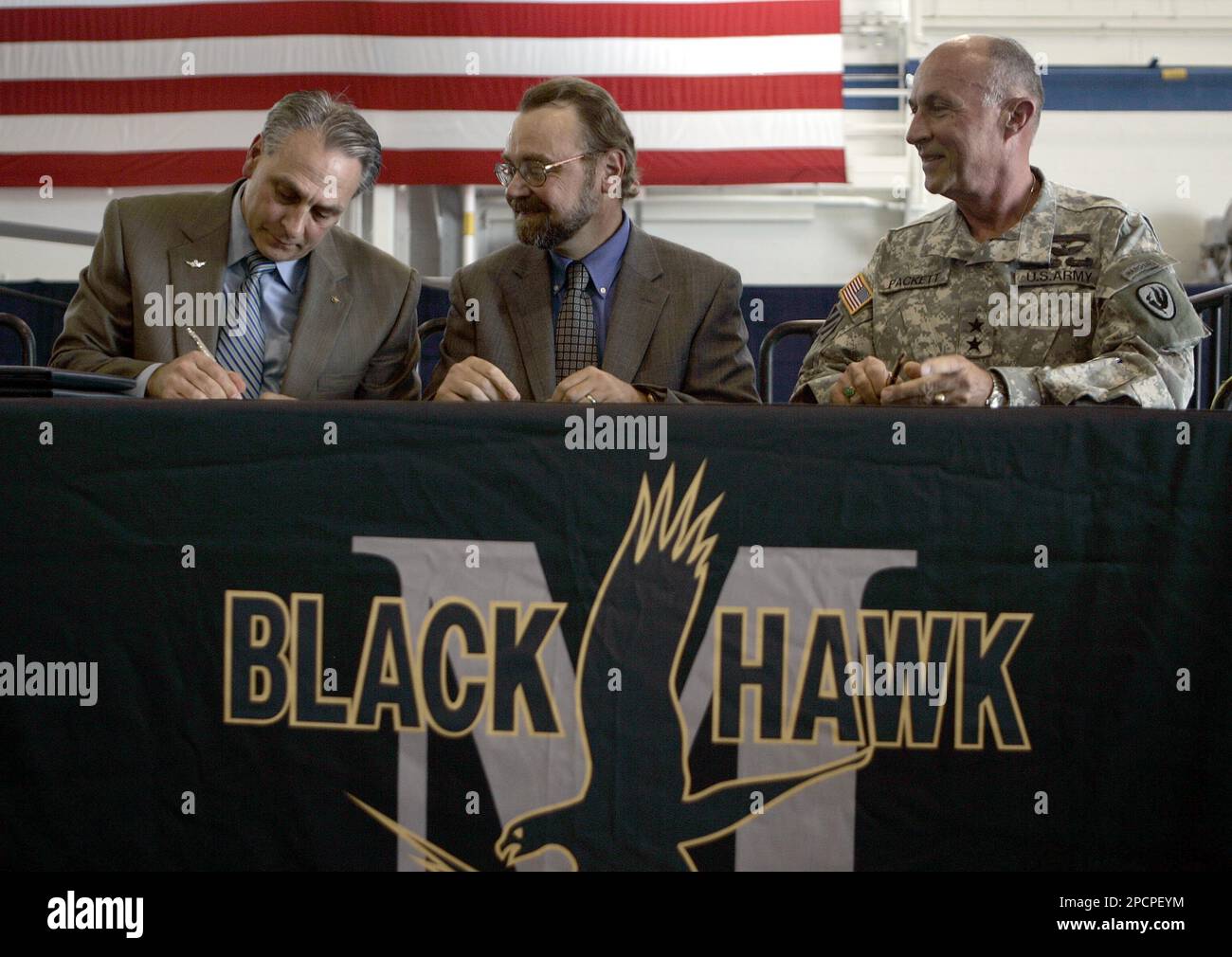 Sikorsky Aircraft President Jeffrey P. Pino, left, signs over the ...