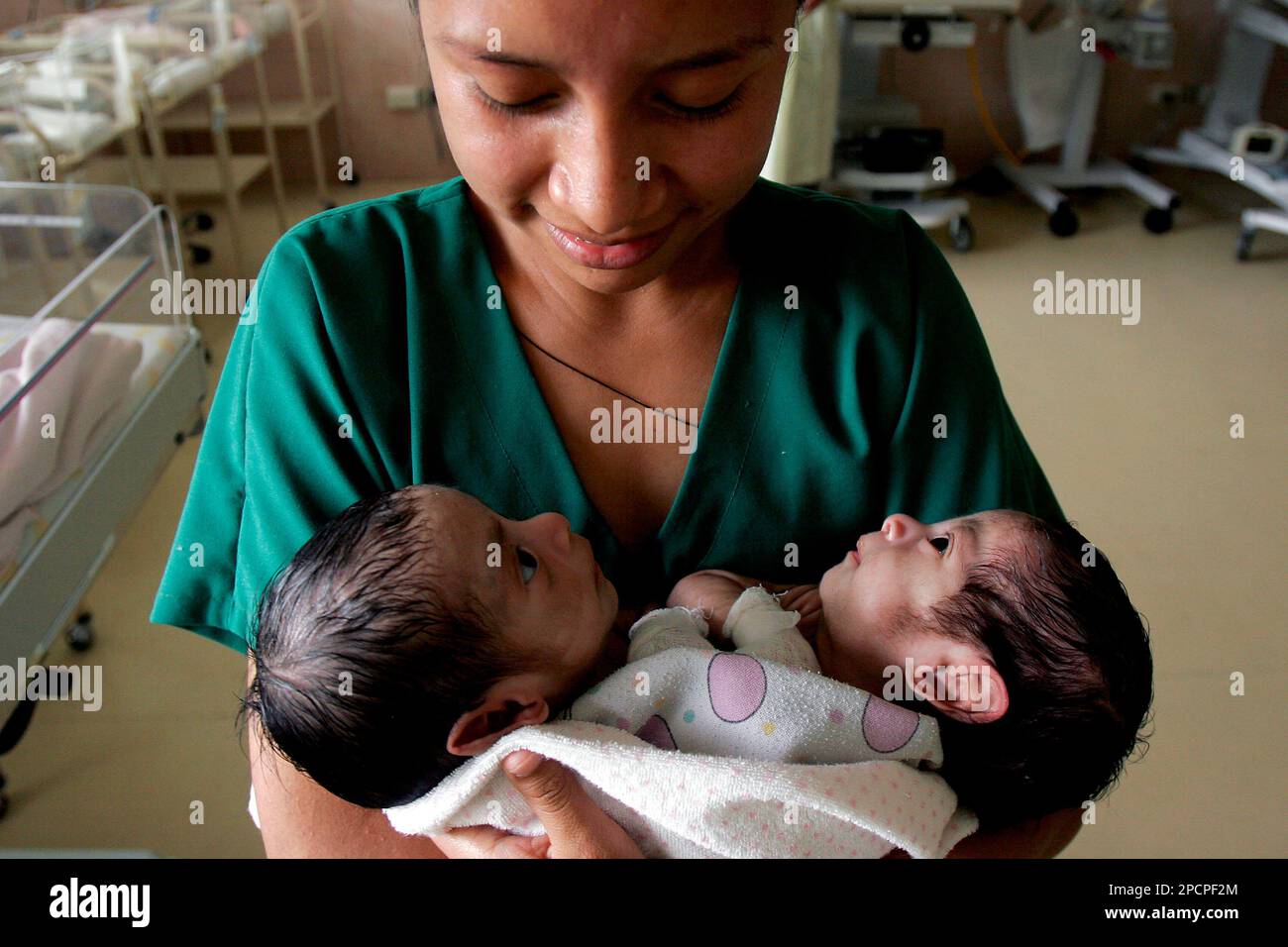 Nurse Guadalupe Cojon holds the one-month-old conjoined twins Angela ...