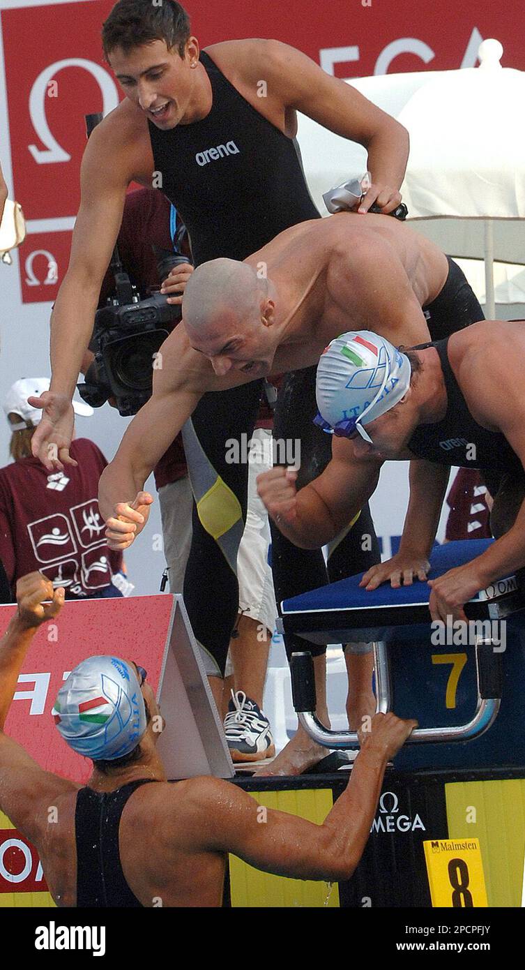 Members of Italy's 4x100 meter relay swimming team celebrate their ...
