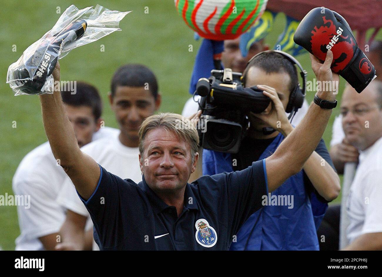 FC Porto's Dutch coach Co Adriaanse salutes fans, with a pair of gloves ...