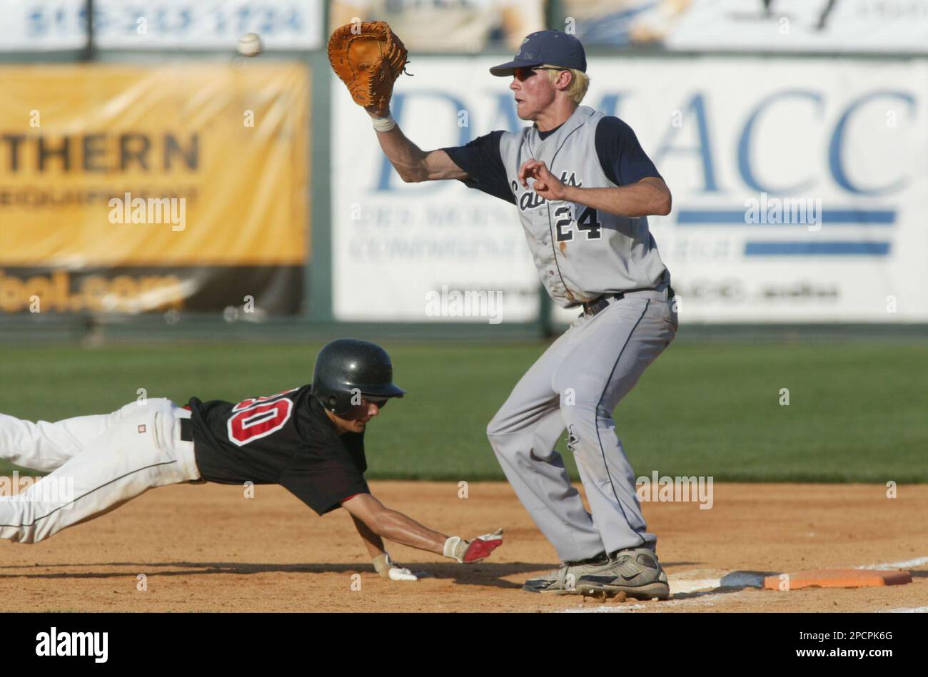 Western Dubuque's Brendan Dardis dashes back to first base as Cedar ...