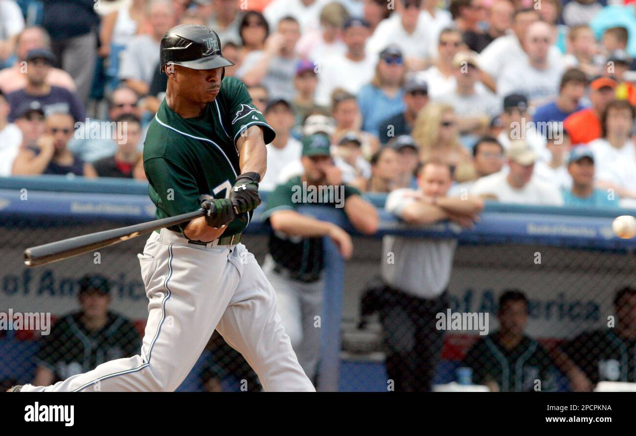 Tampa Bay Devil Rays' Damon Hollins follows through on a home run ...