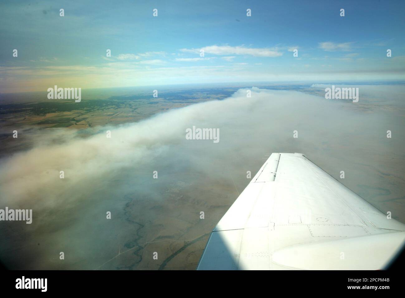 An aerial view of smoke from several wildfires is seen from an airplane ...