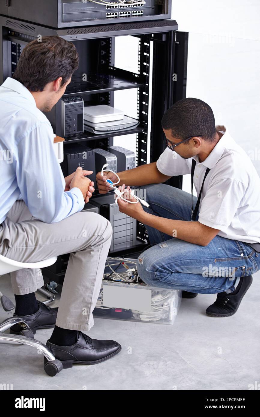Computer repair. A technician fixing his clients electronic device ...