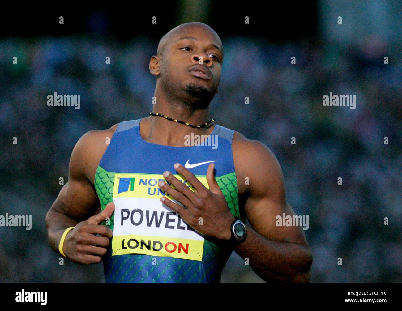 Jamaica's Asafa Powell is seen after crossing the line to win the men's ...