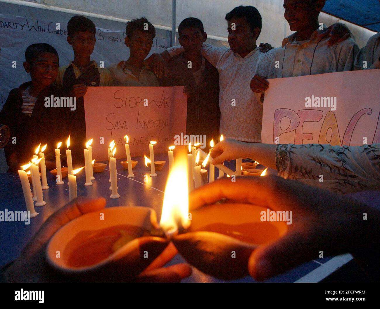 Young Pakistani protesters light candles, Thursday, July 27, 2006 in ...
